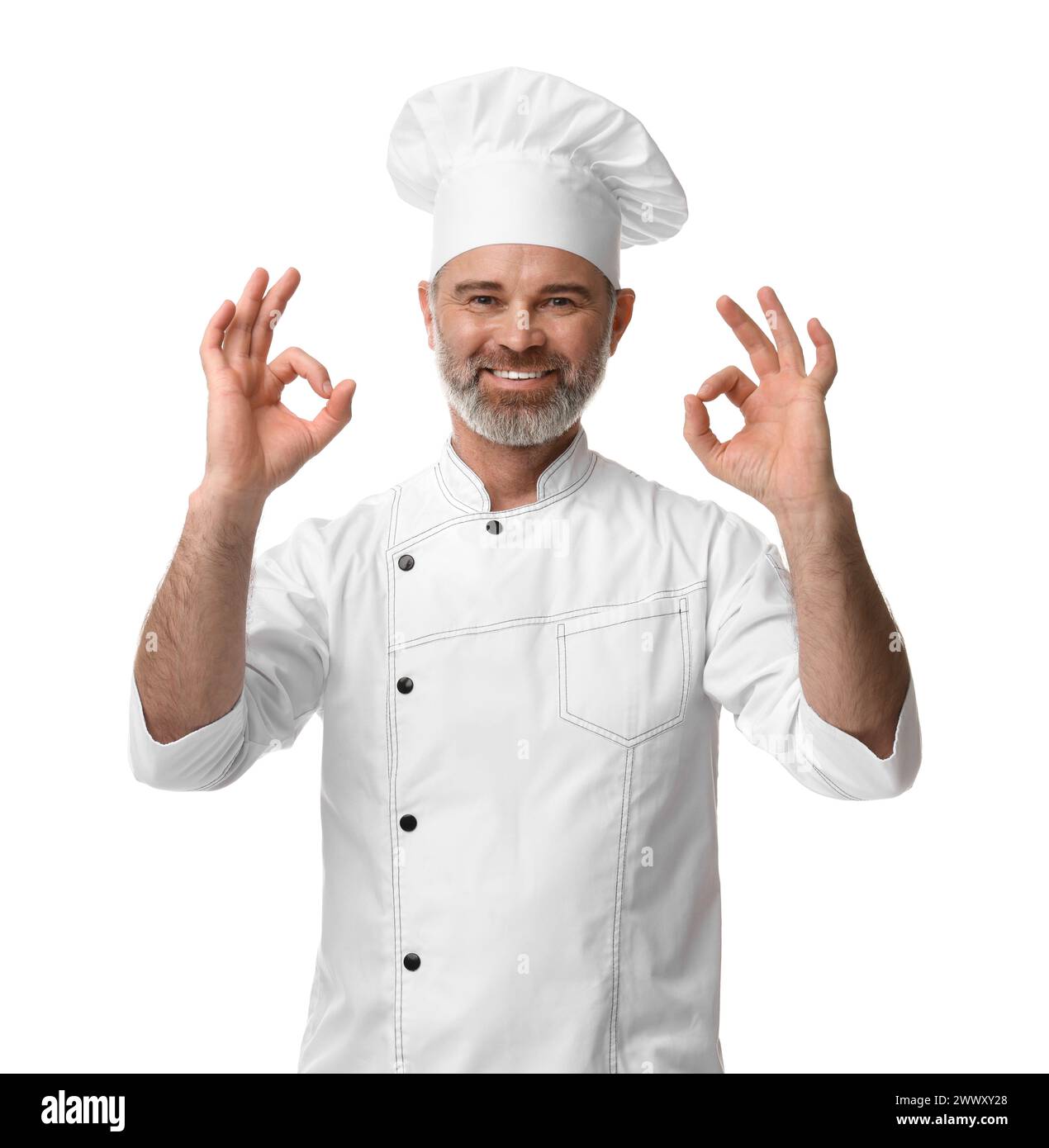 Happy chef in uniform showing OK gesture on white background Stock ...