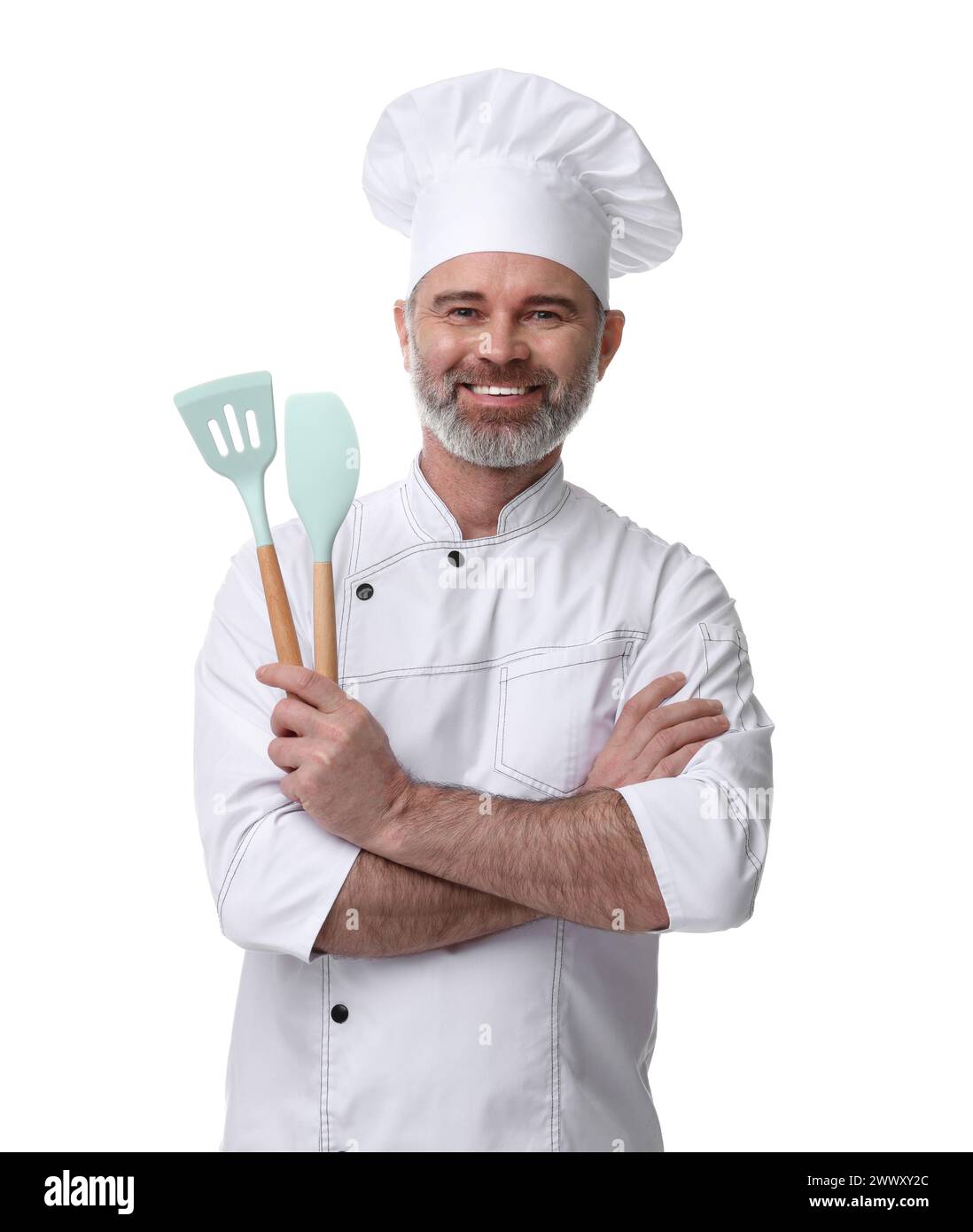 Happy chef in uniform holding kitchen utensils on white background ...