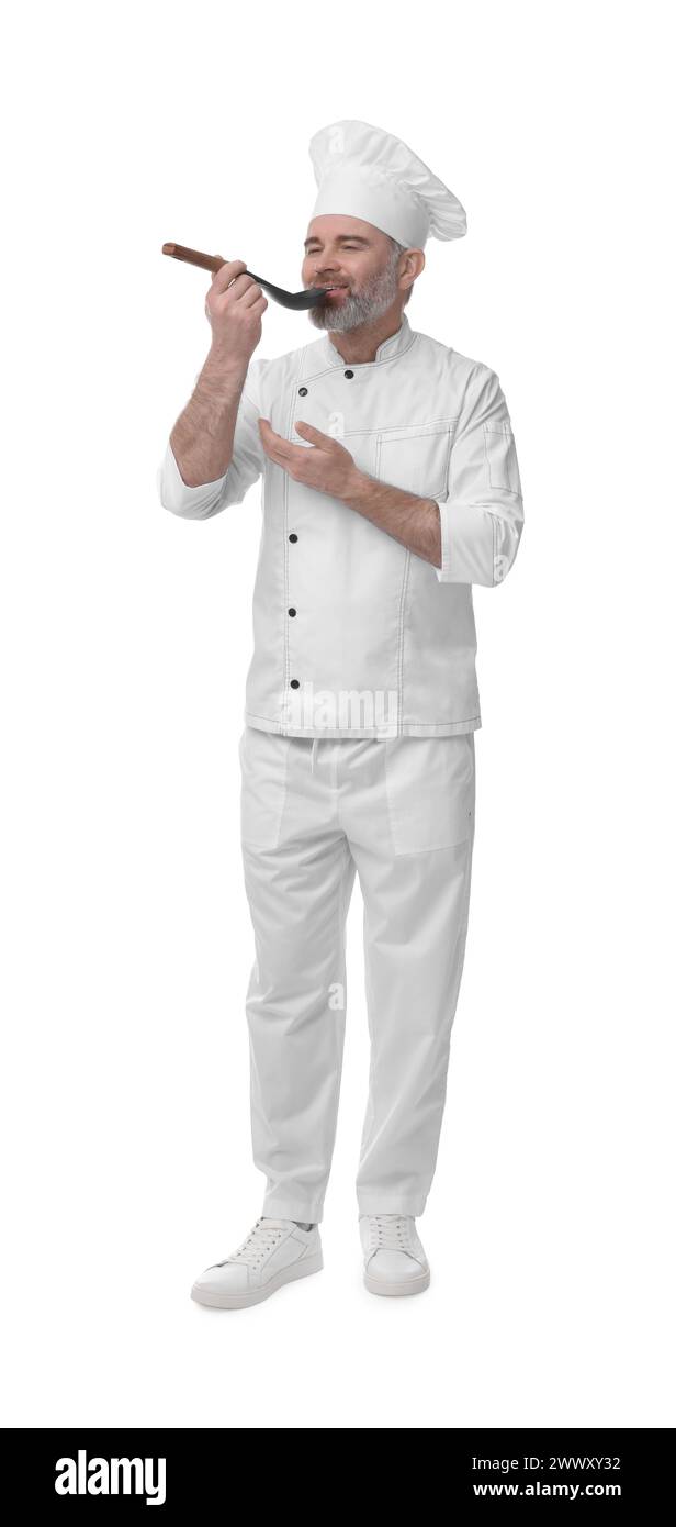 Chef in uniform tasting something on white background Stock Photo - Alamy