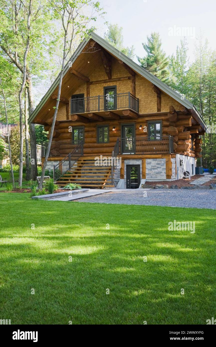 Luxurious two story Scandinavian style log cabin home facade in late ...