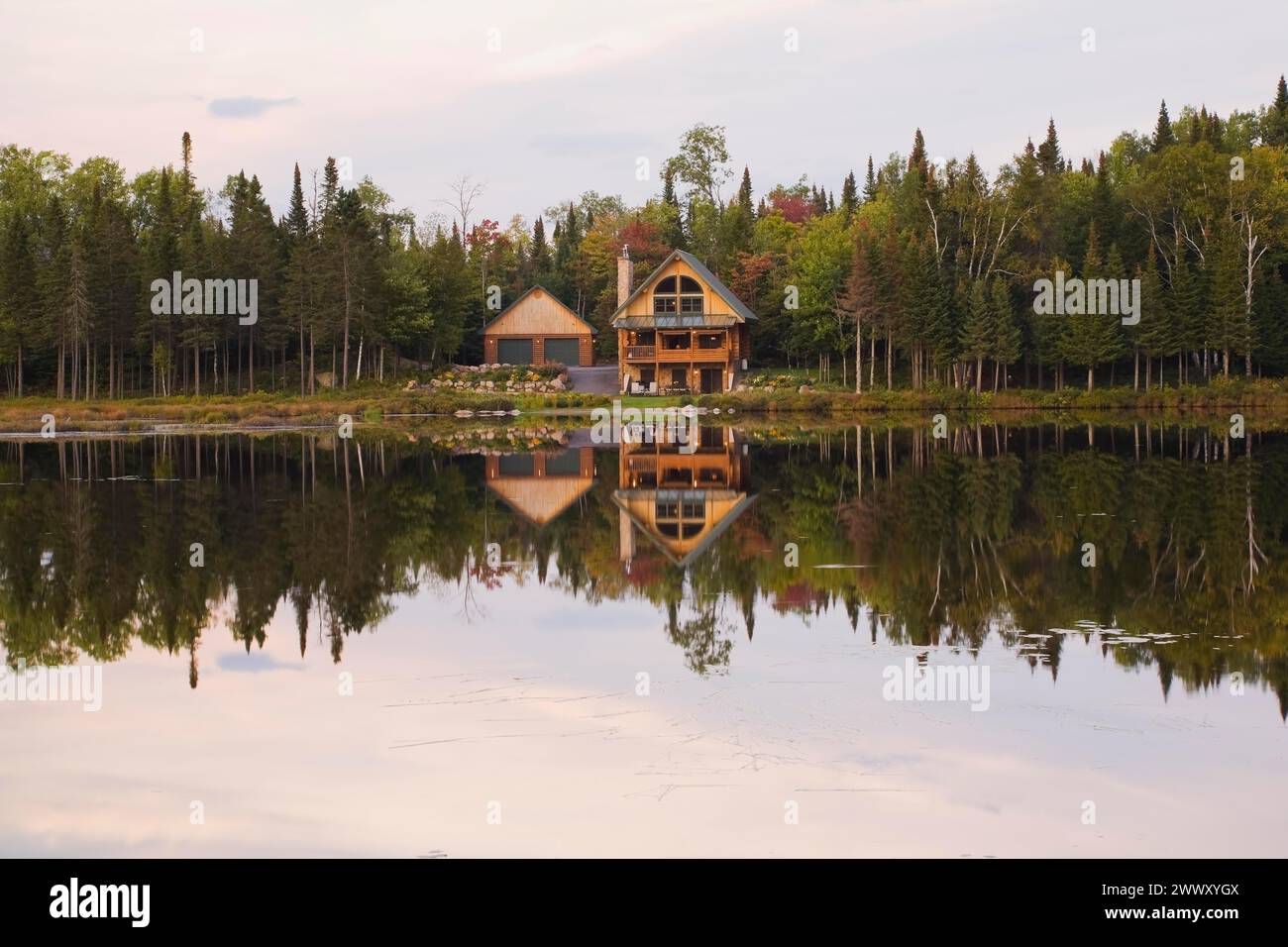 Garage and handcrafted two story spruce log cabin home with fieldstone ...