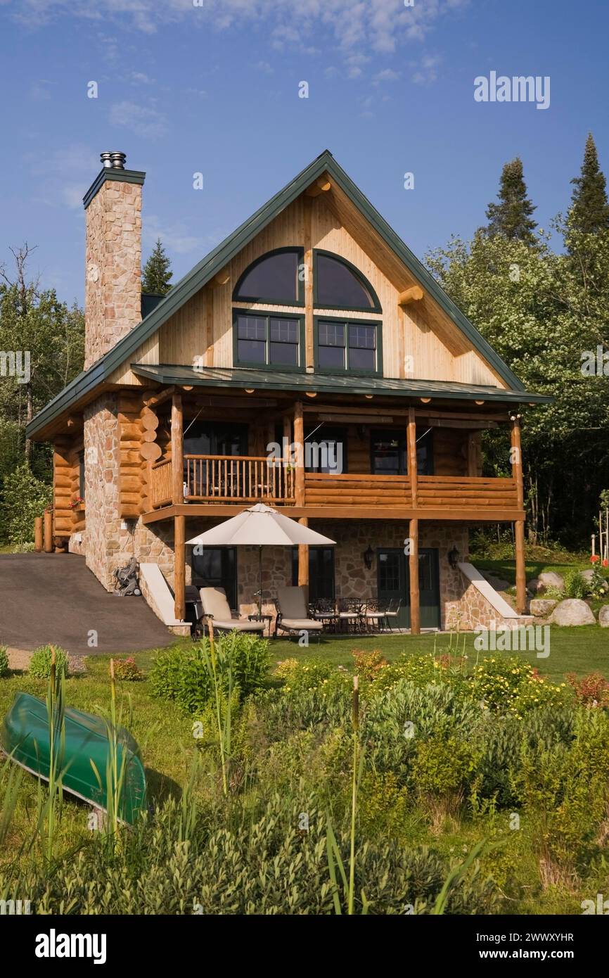 Handcrafted two story spruce log home cabin with fieldstone chimney ...