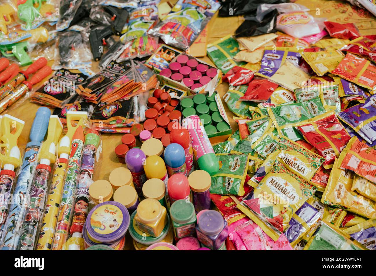 Vendor sells Holi celebration items in a street market, ahead of Holi ...