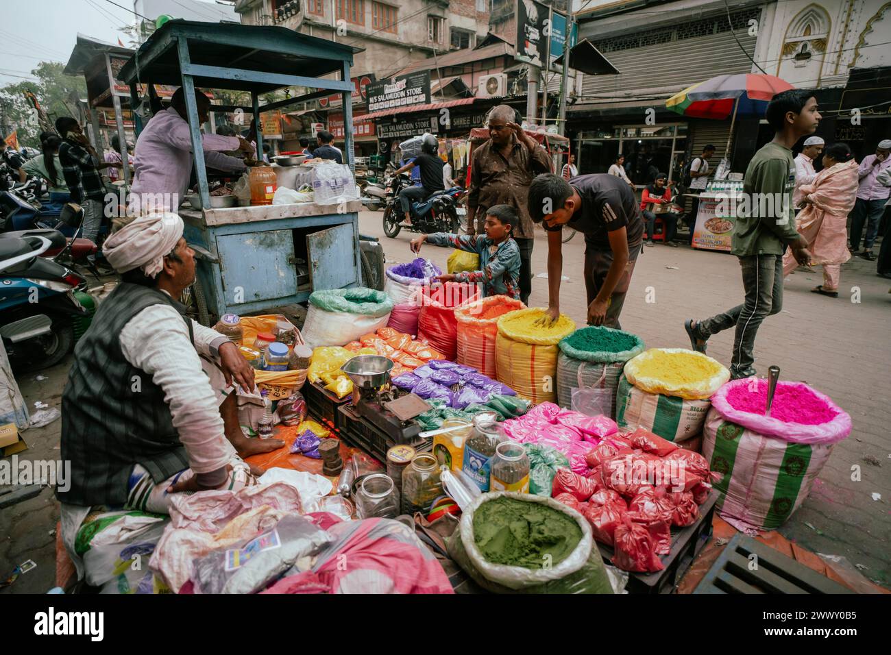 Vendor sells Holi celebration items in a street market, ahead of Holi ...