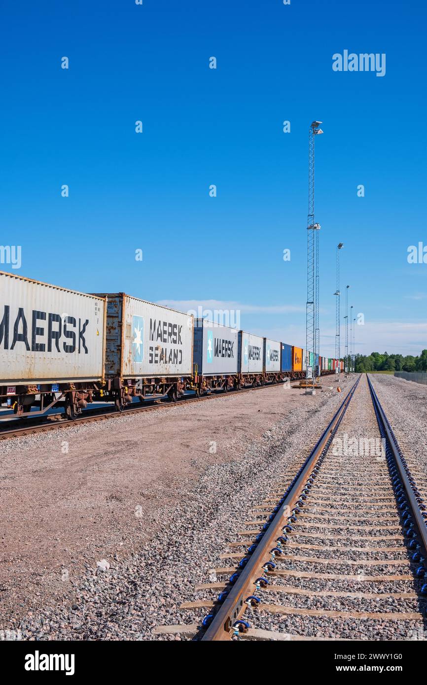 Train with containers on railway wagons on a track area Stock Photo - Alamy