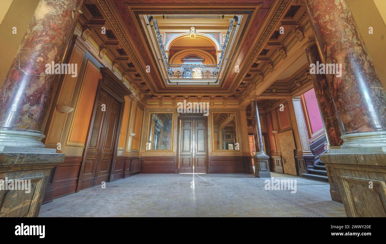 A magnificent corridor with marble columns and richly decorated ...