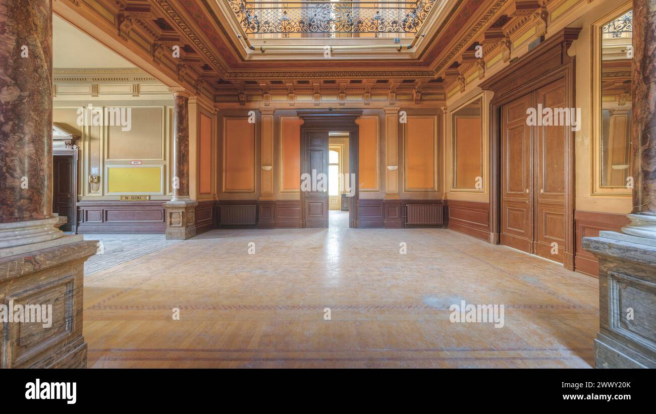 Empty interior of a historic building with wood panelling and columns ...