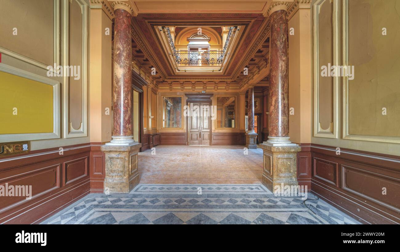Impressive entrance hall with classical columns and a decoratively ...