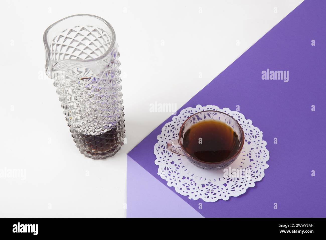 a violet cube made with colored paper to create a 3D optical illusion ...