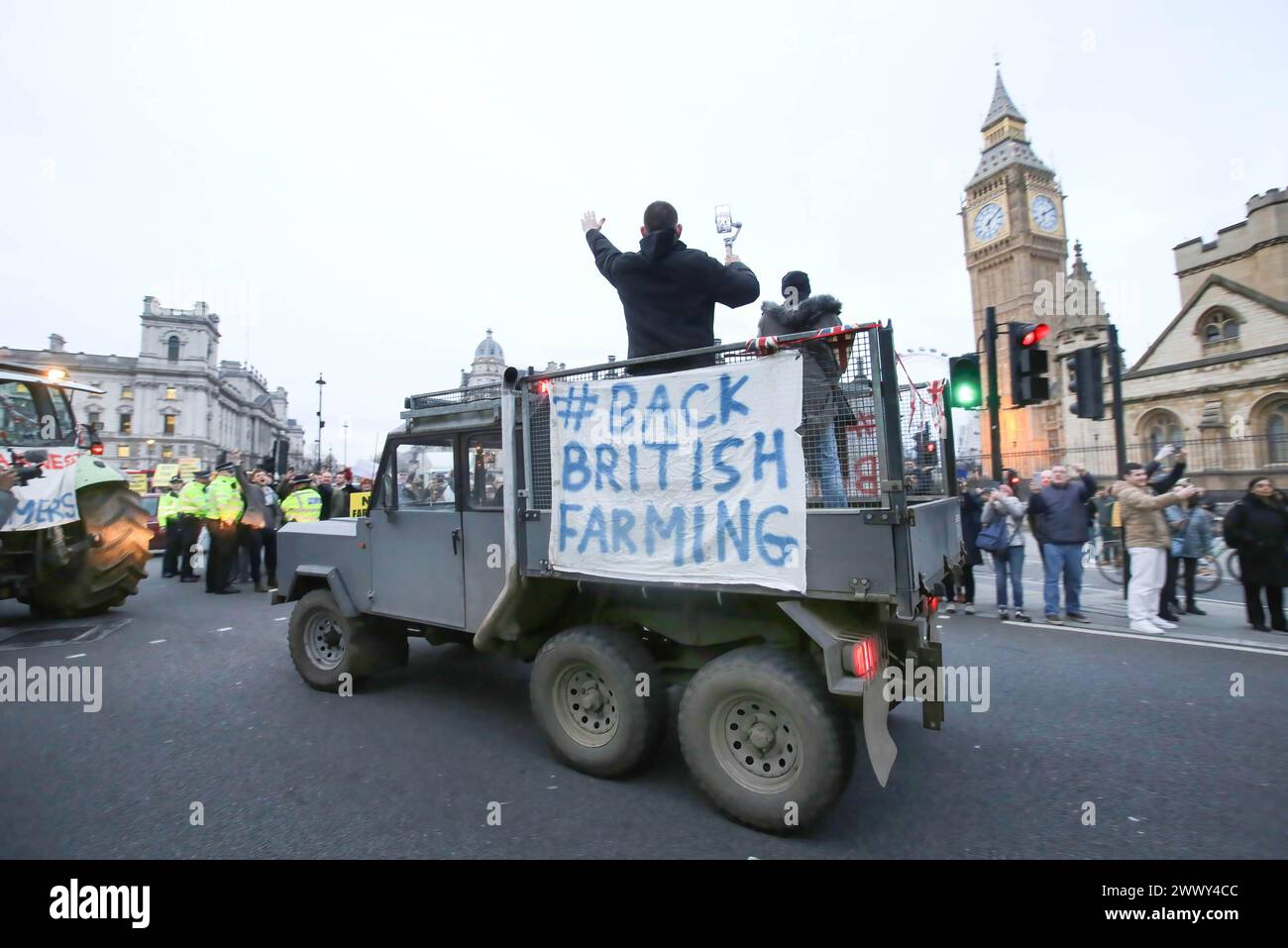 A protester acknowledges the applause of the crowd as his truck with a ...