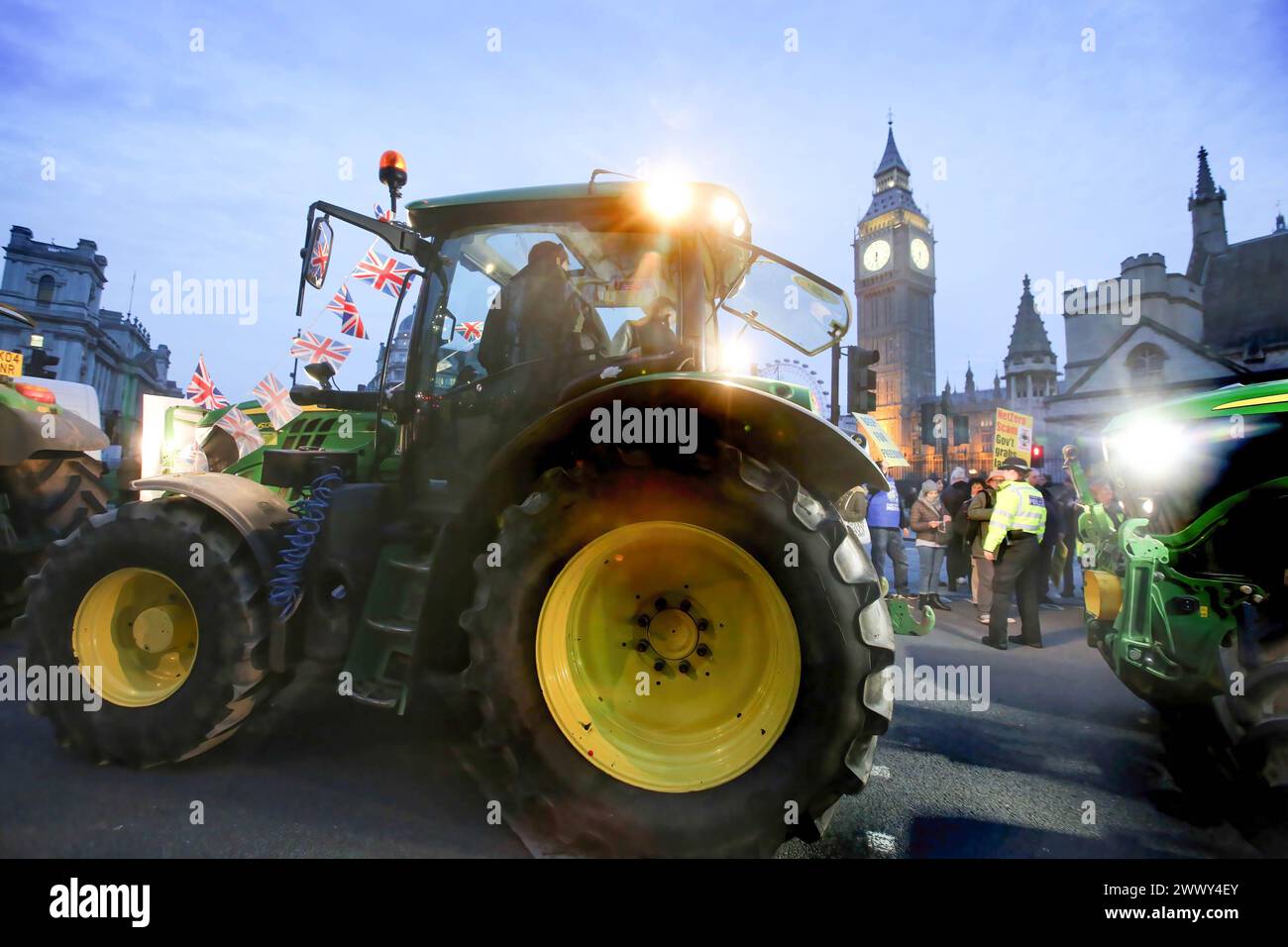 Supporters hold up anti-government signs of support as tractors stream ...