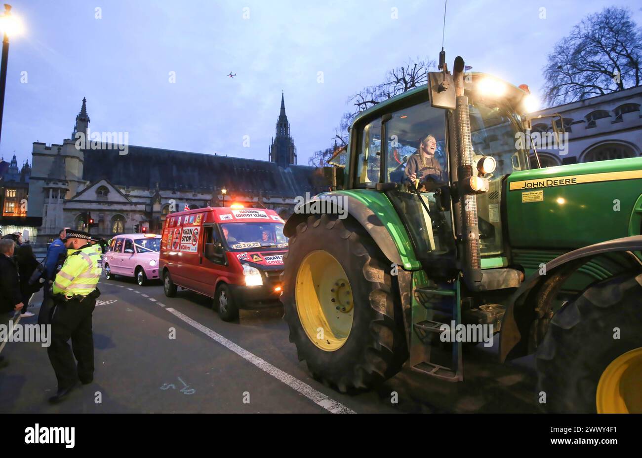 A tractor with a young woman driving edges around Parliament Square as ...