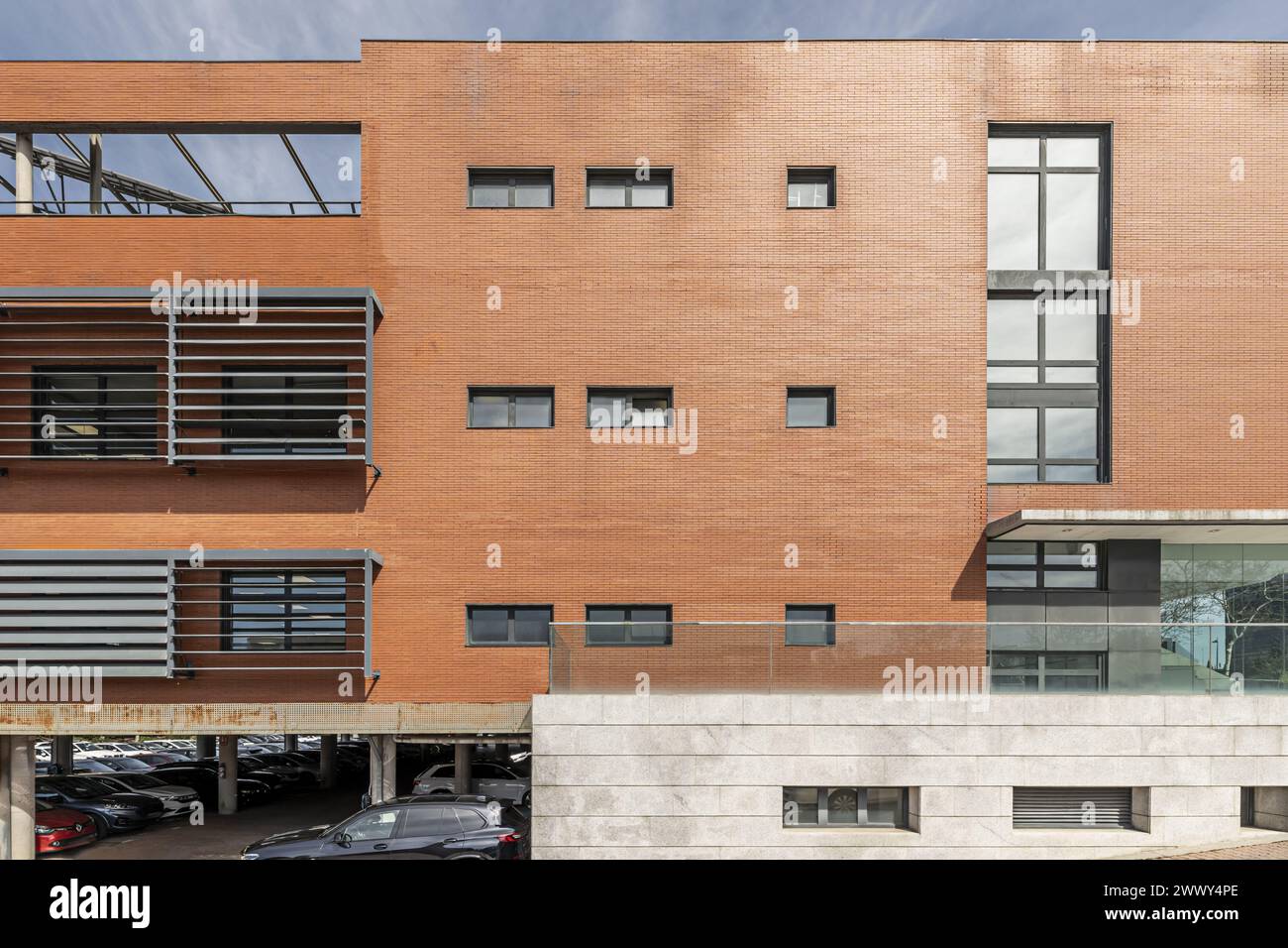 Front image of office building facade with light brown brick wall on a ...