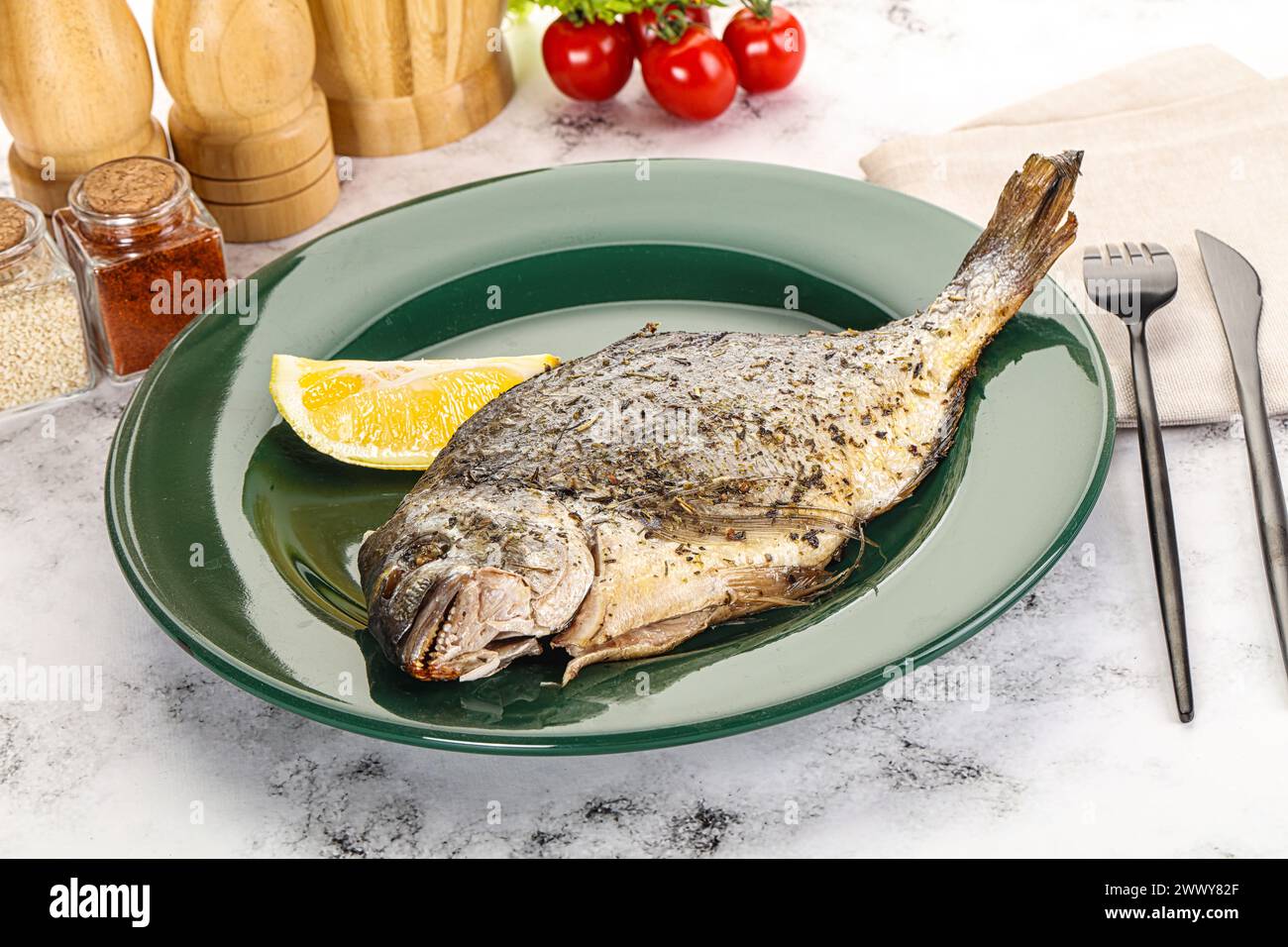 Baked Dorado fish served lemon slice Stock Photo - Alamy