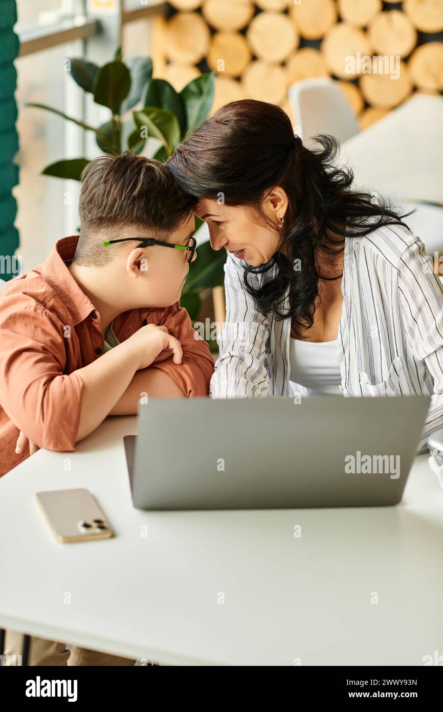 loving cheerful mother having quality time with her inclusive jolly son ...