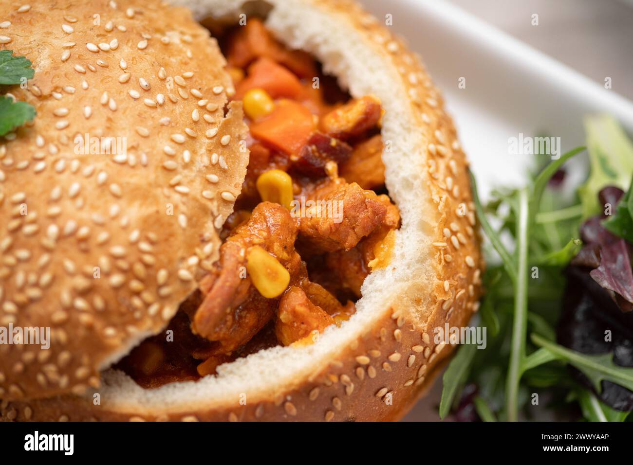 Meat goulash in bread, close-up. Menu Stock Photo - Alamy