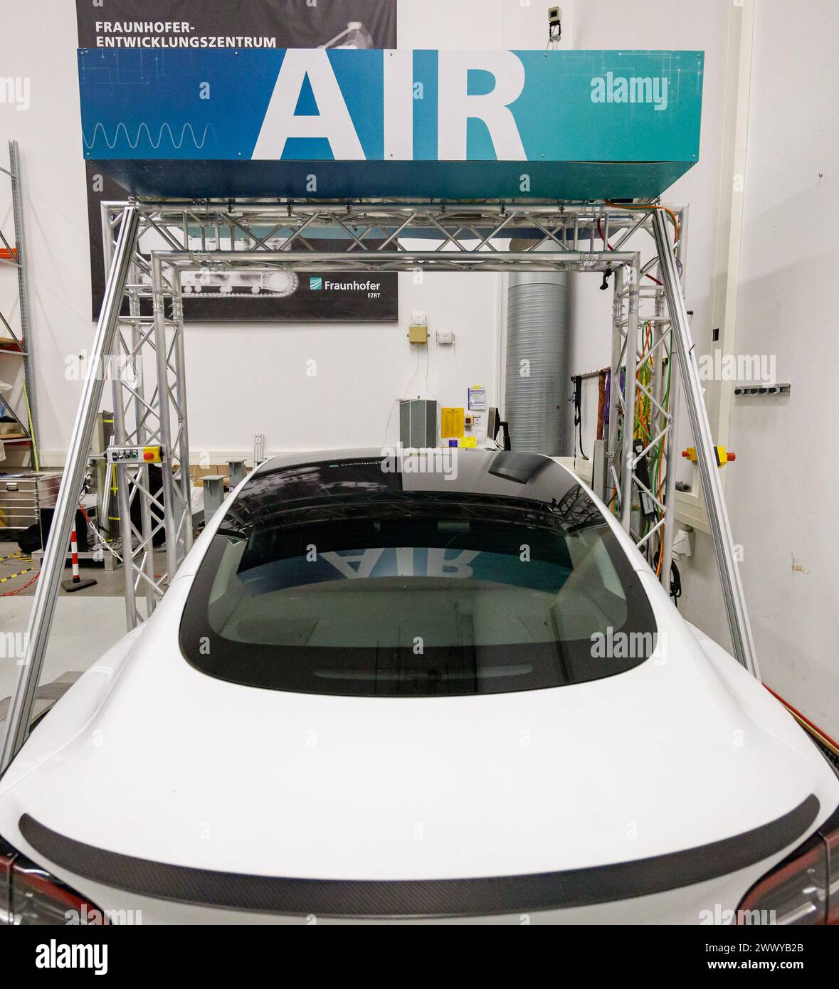 26 March 2024, Bavaria, Fürth: An electric vehicle stands under the ...