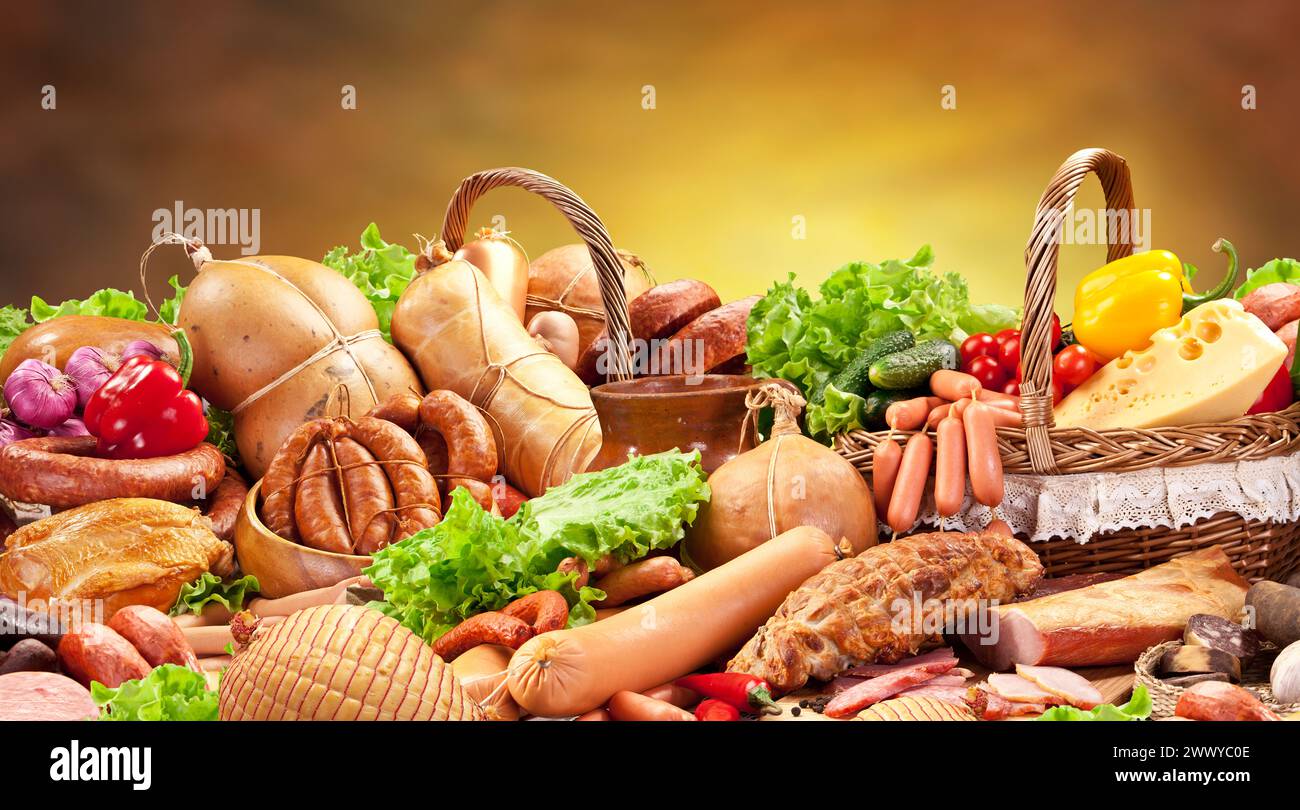Varied assortment of prepared meats and sausages with vegetables and ...