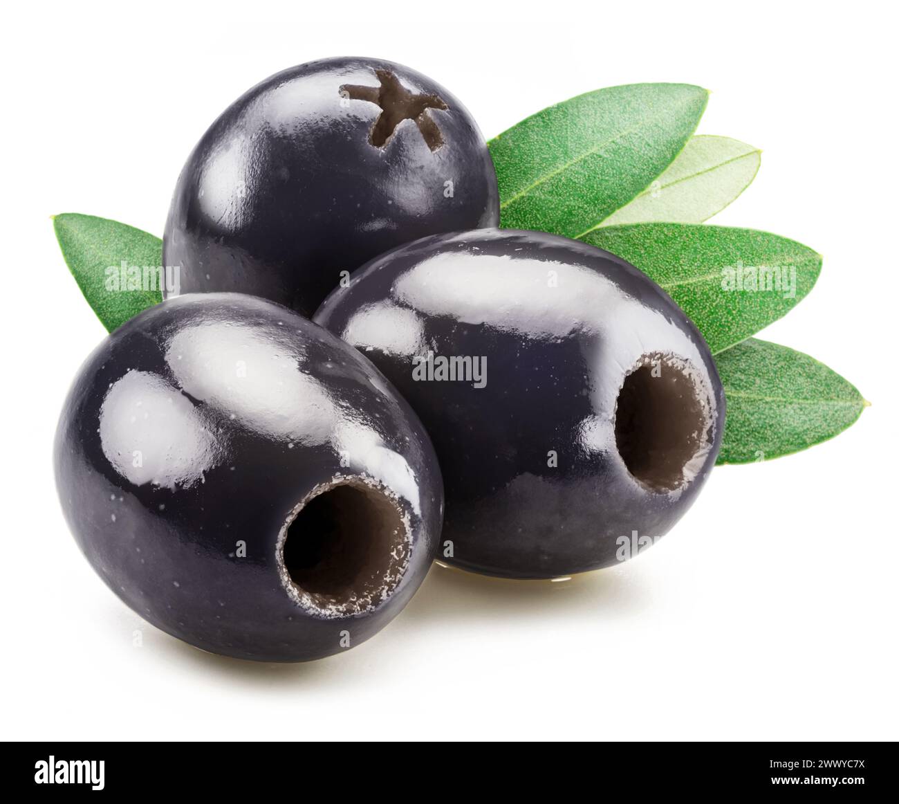 Three pitted black olives with olive leaves isolated on white ...