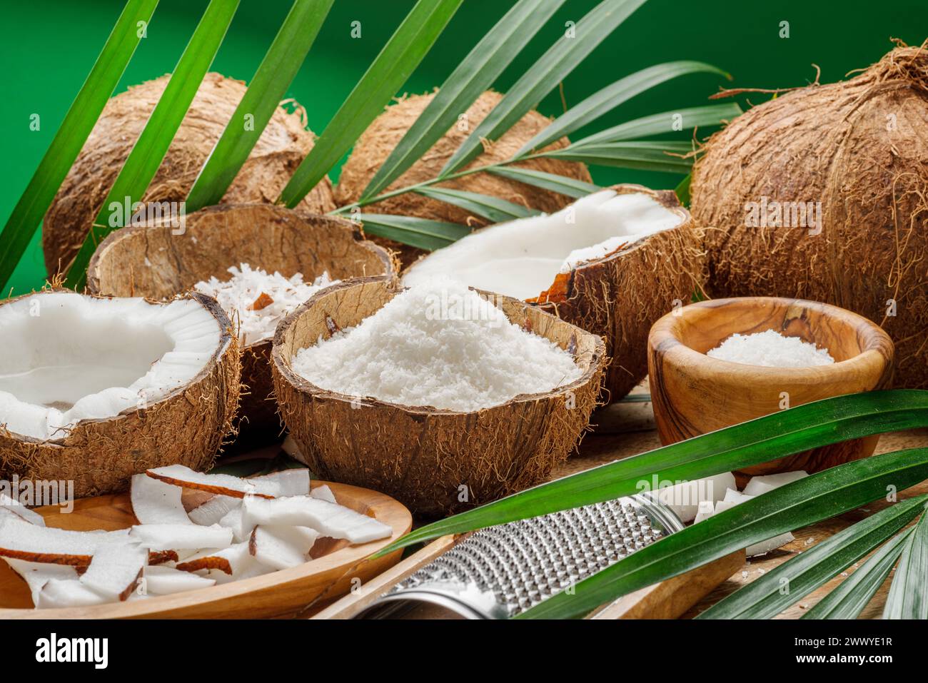 Fresh opened coconuts along with coconut slices, flakes and coconut ...