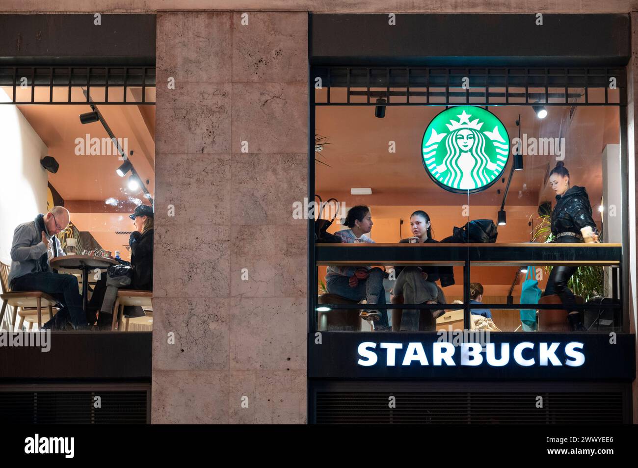 Customers are seen at the American multinational chain Starbucks Coffee ...