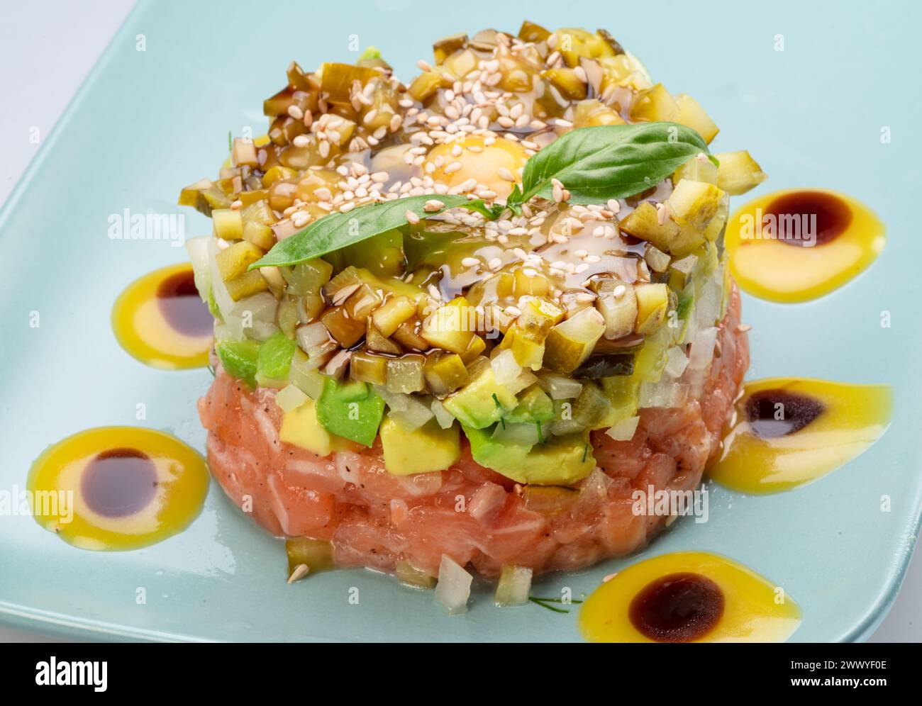 Salmon tartare dish on blue plate close up Stock Photo - Alamy