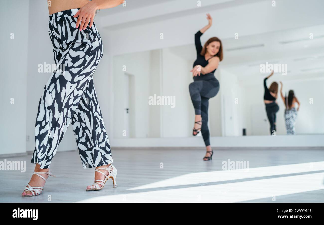 Graceful dancing women group doing elegant dance movements in white ...