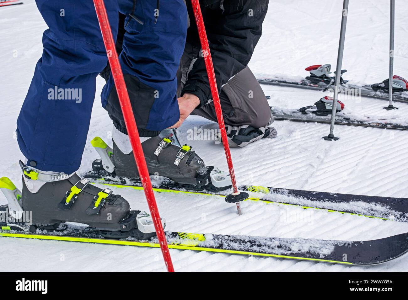 help fasten your boots on a soft slope. family active recreation Stock ...