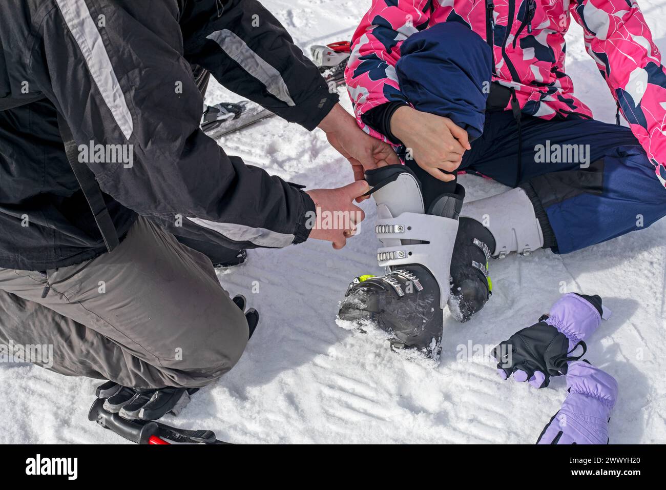 help fasten your boots on a soft slope. family active recreation Stock ...