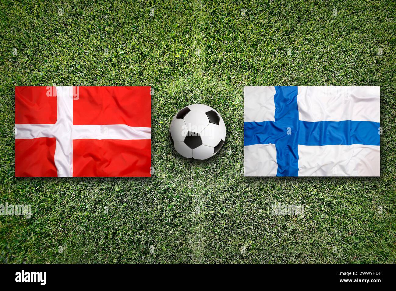 Denmark vs. Finland flags on green soccer field Stock Photo - Alamy