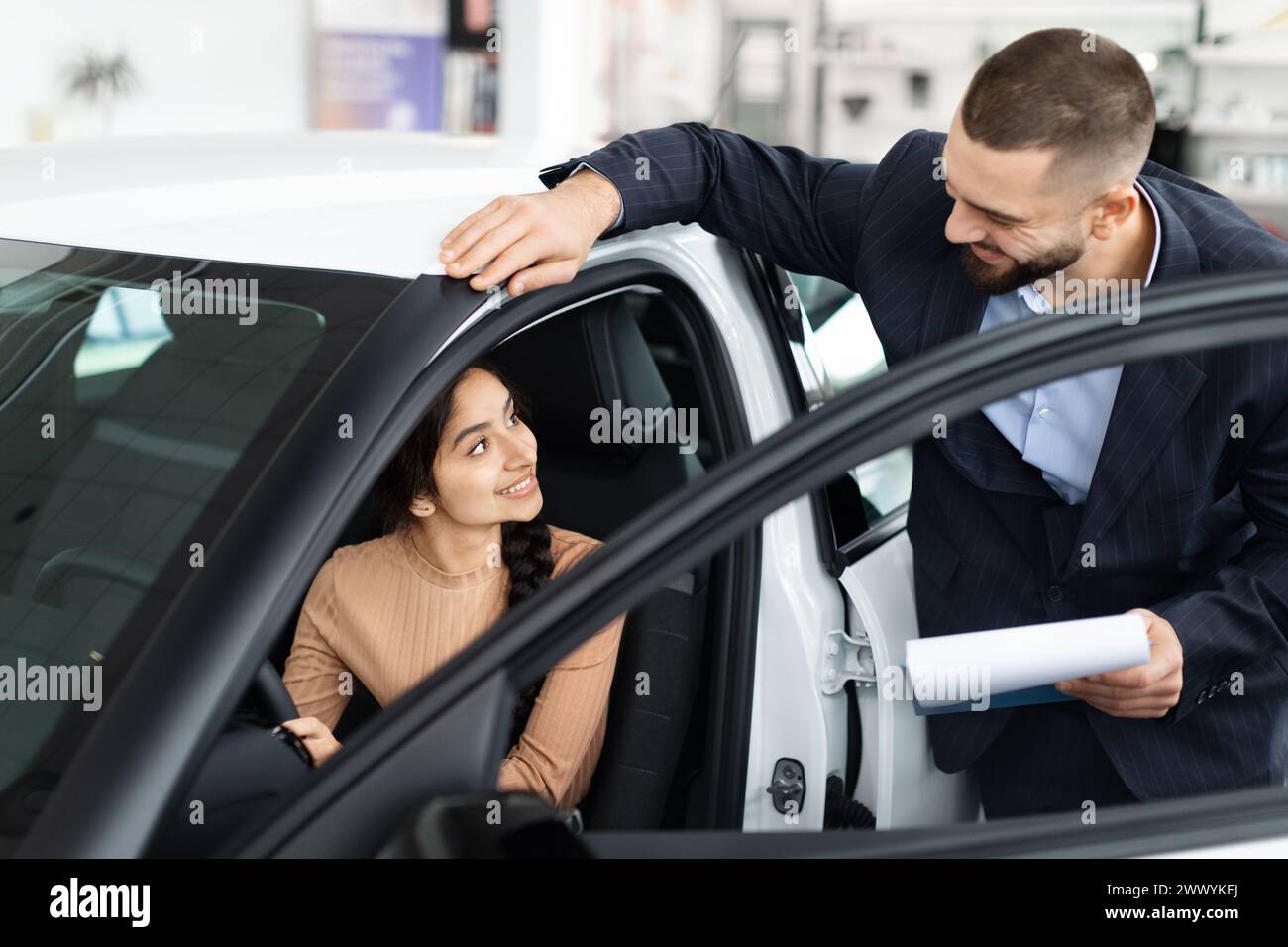 Car salesman explaining car features hi-res stock photography and ...