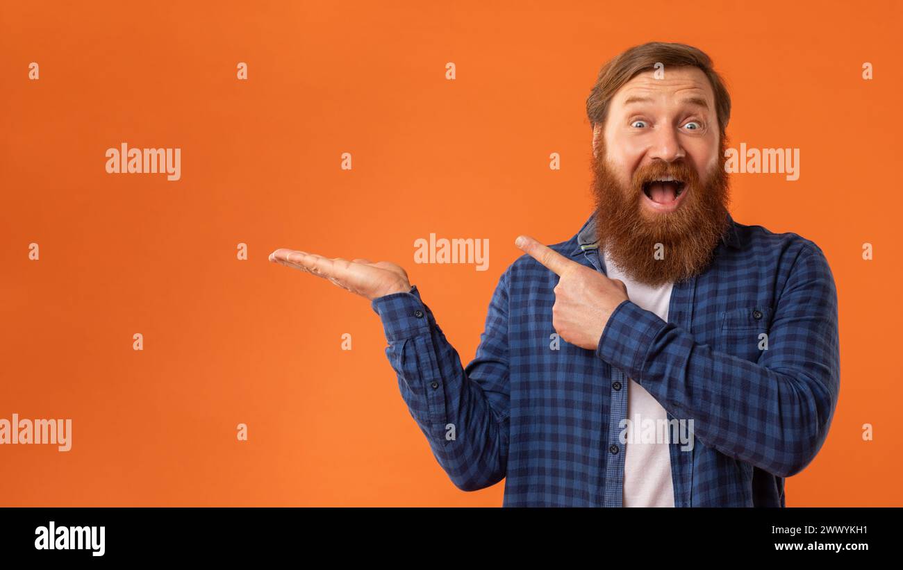 Funny Redhaired Man Pointing Finger At His Open Palm, Studio Stock ...