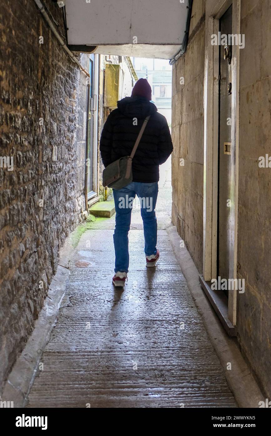 March 2024 - Man walking down a passage way in the city of Bath ...