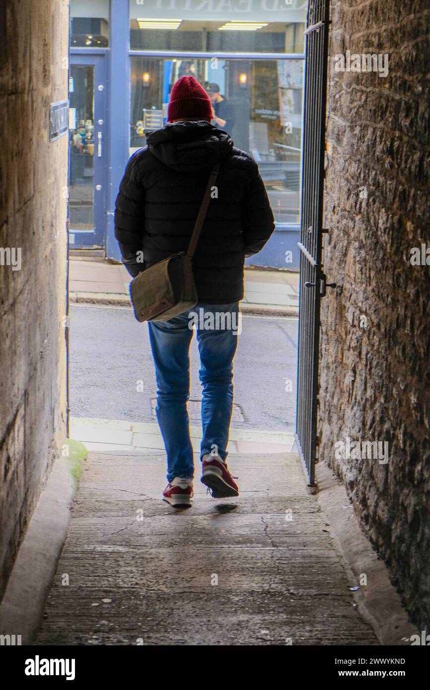 March 2024 - Man walking down a passage way in the city of Bath ...