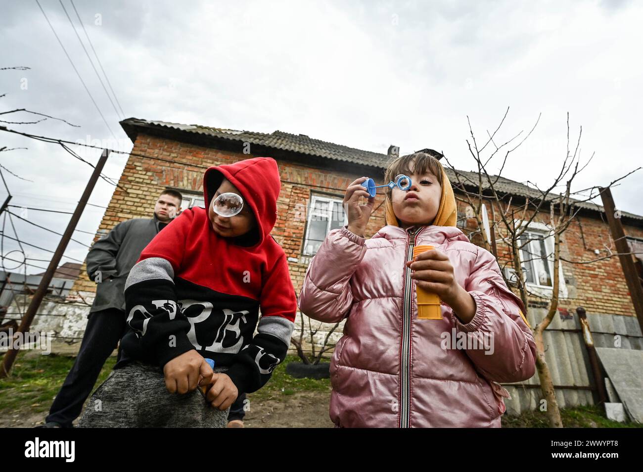 PRYMORSKE, UKRAINE - MARCH 20, 2024 - A girl blows soap bubbles next to ...