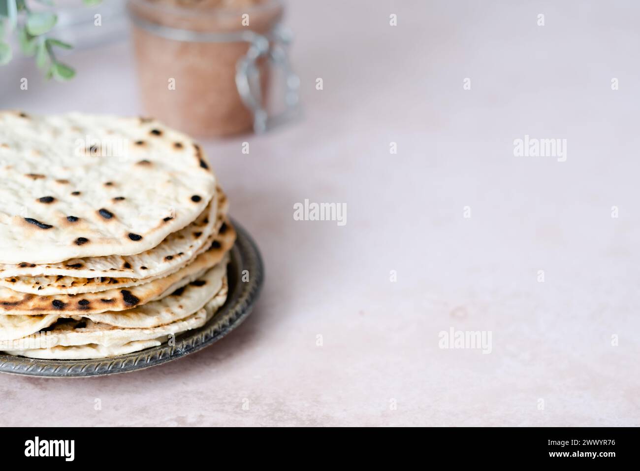 Handmade round matzo in a plate. Sweet condiment with apple-walnut ...