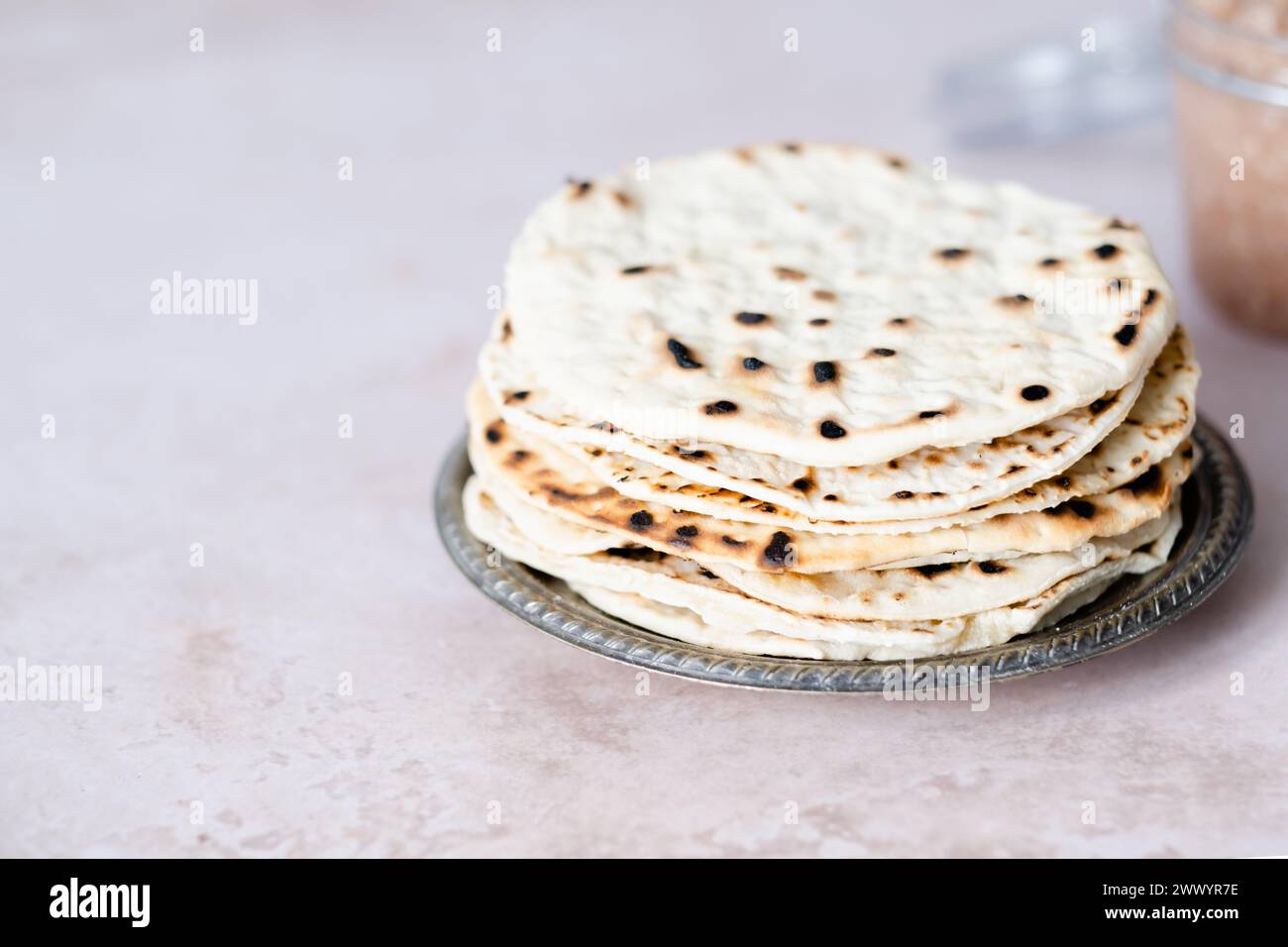 Handmade round matzo in a plate. Sweet condiment with apple-walnut ...
