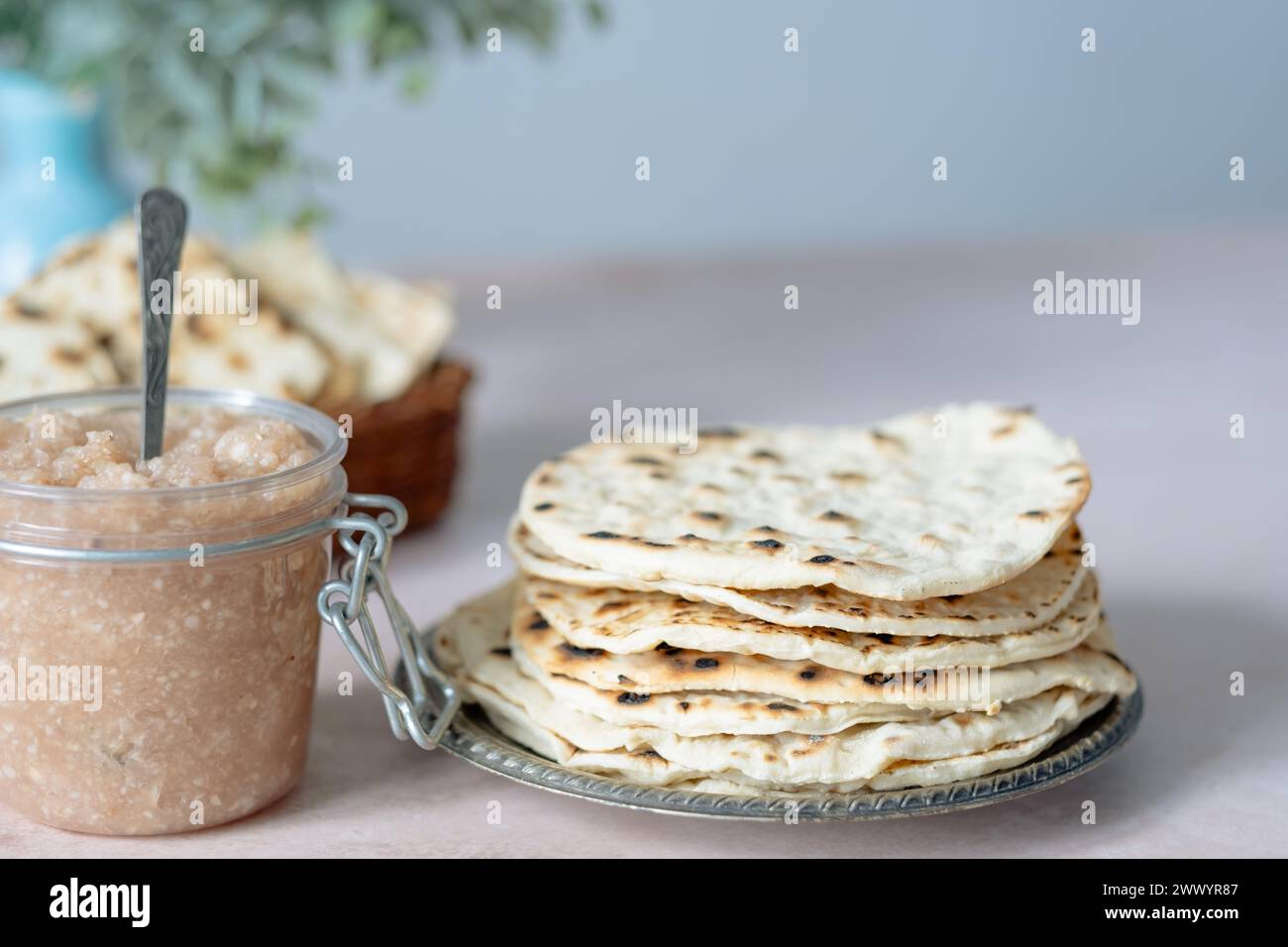 Handmade round matzo in a plate. Sweet condiment with apple-walnut ...