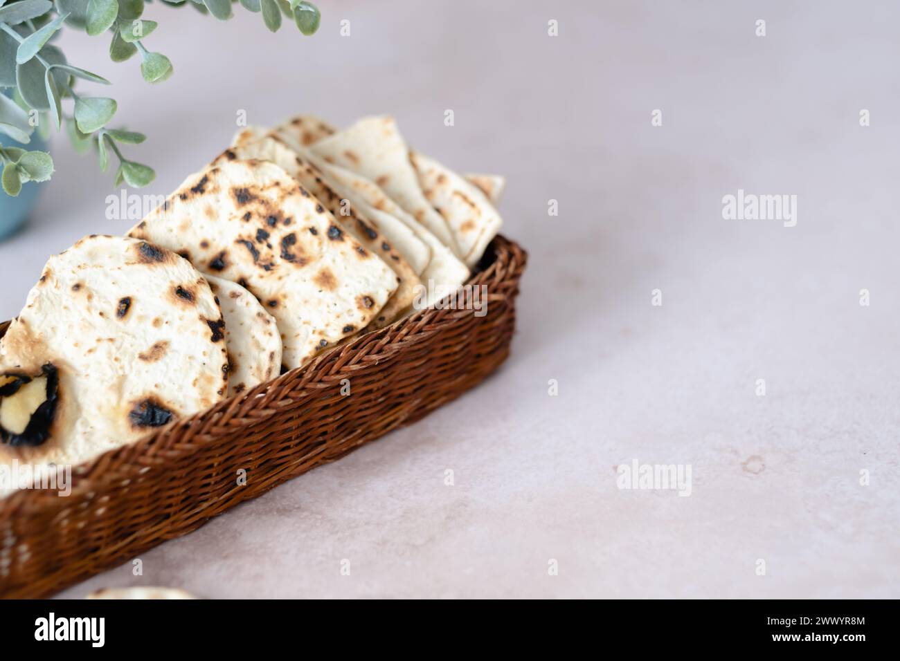 Handmade matzo in a wicker basket. Sweet condiment with apple-walnut ...