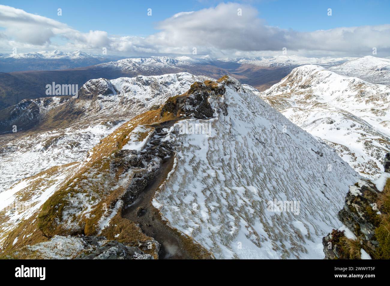 The narrow ridge just beyond the rocky summit of Meall Garbh with Beinn ...
