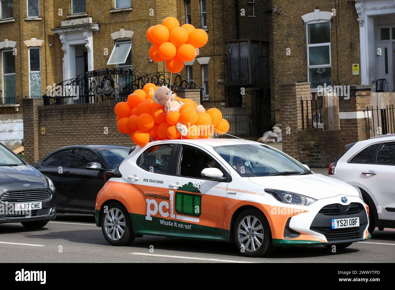 A car with balloons drives through in Stamford Hill, north London ...