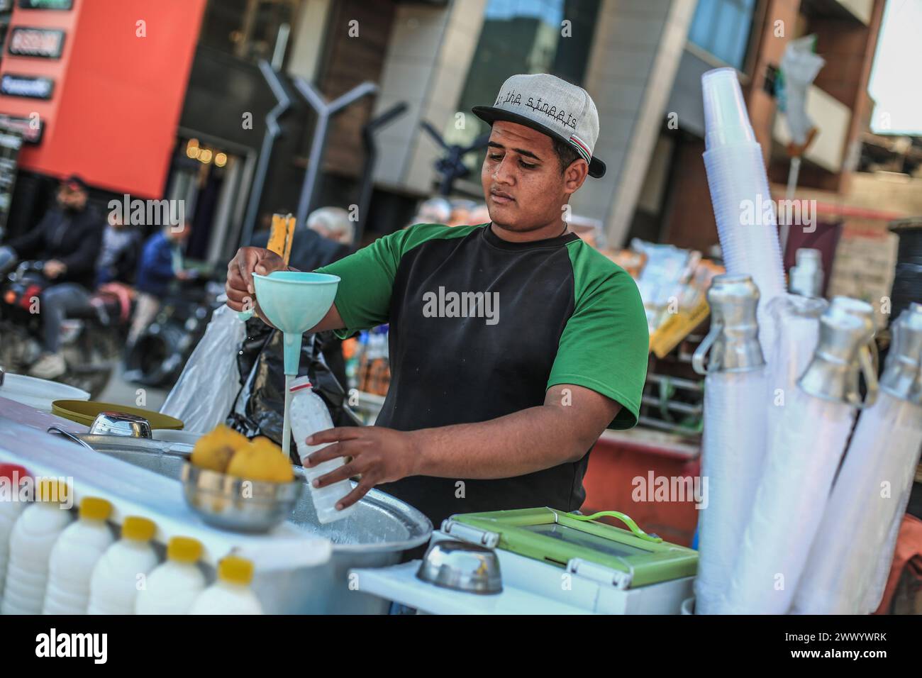Baghdad, Iraq. 26th Mar, 2024. An Iraqi vendor sells juice in a market ...