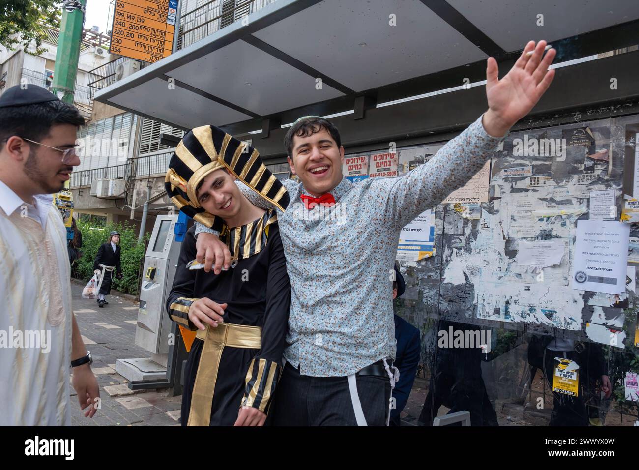 Young men, one is dressed as an Egyptian Pharaoh celebrate Purim. Ultra ...