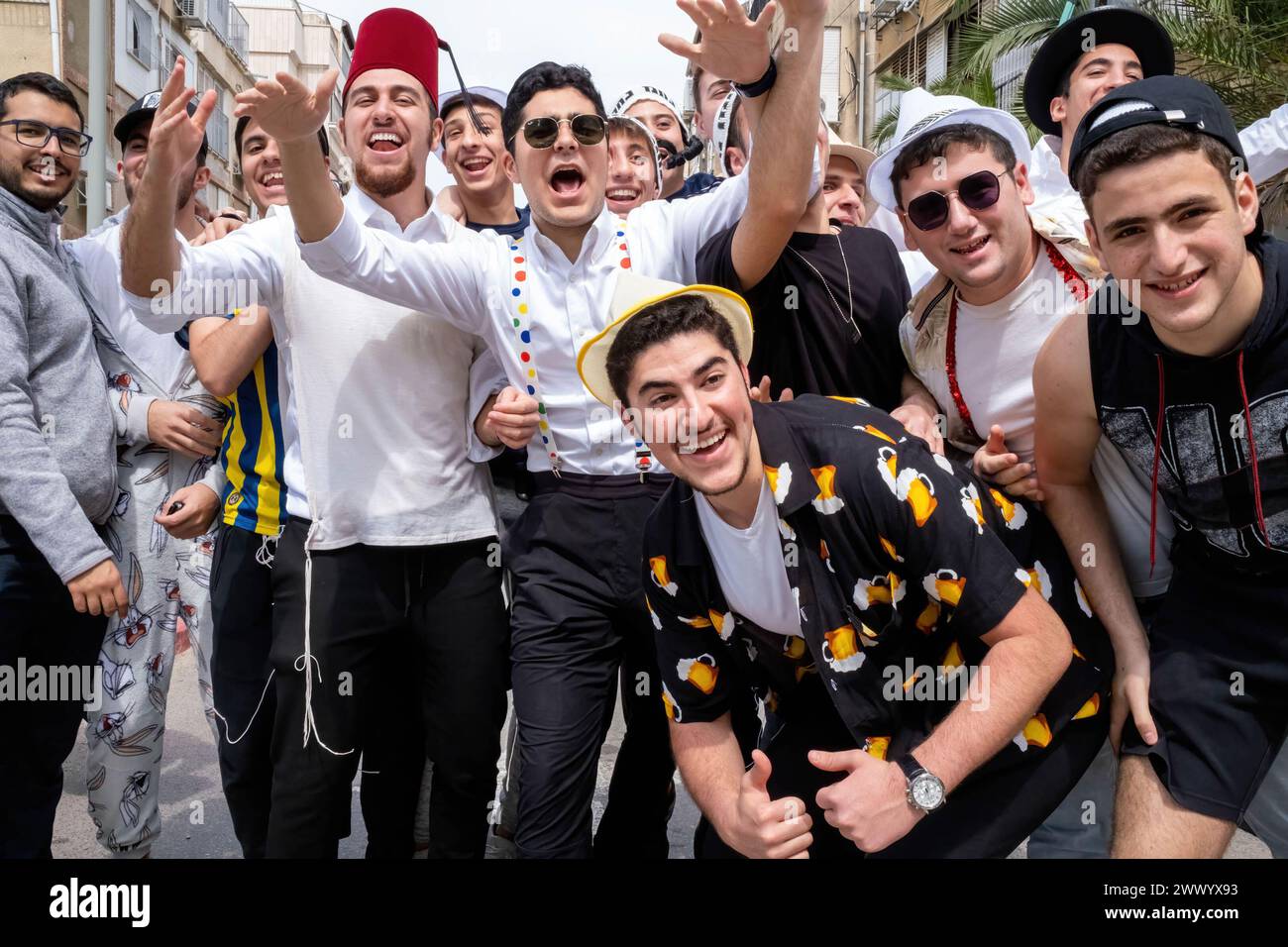 A group of young men pose for the camera during the Purim celebrations ...