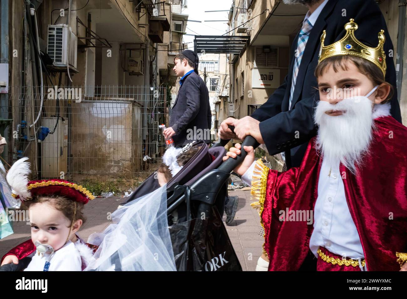 Bnei Brak, Israel. 24th Mar, 2024. A father is seen with his two ...