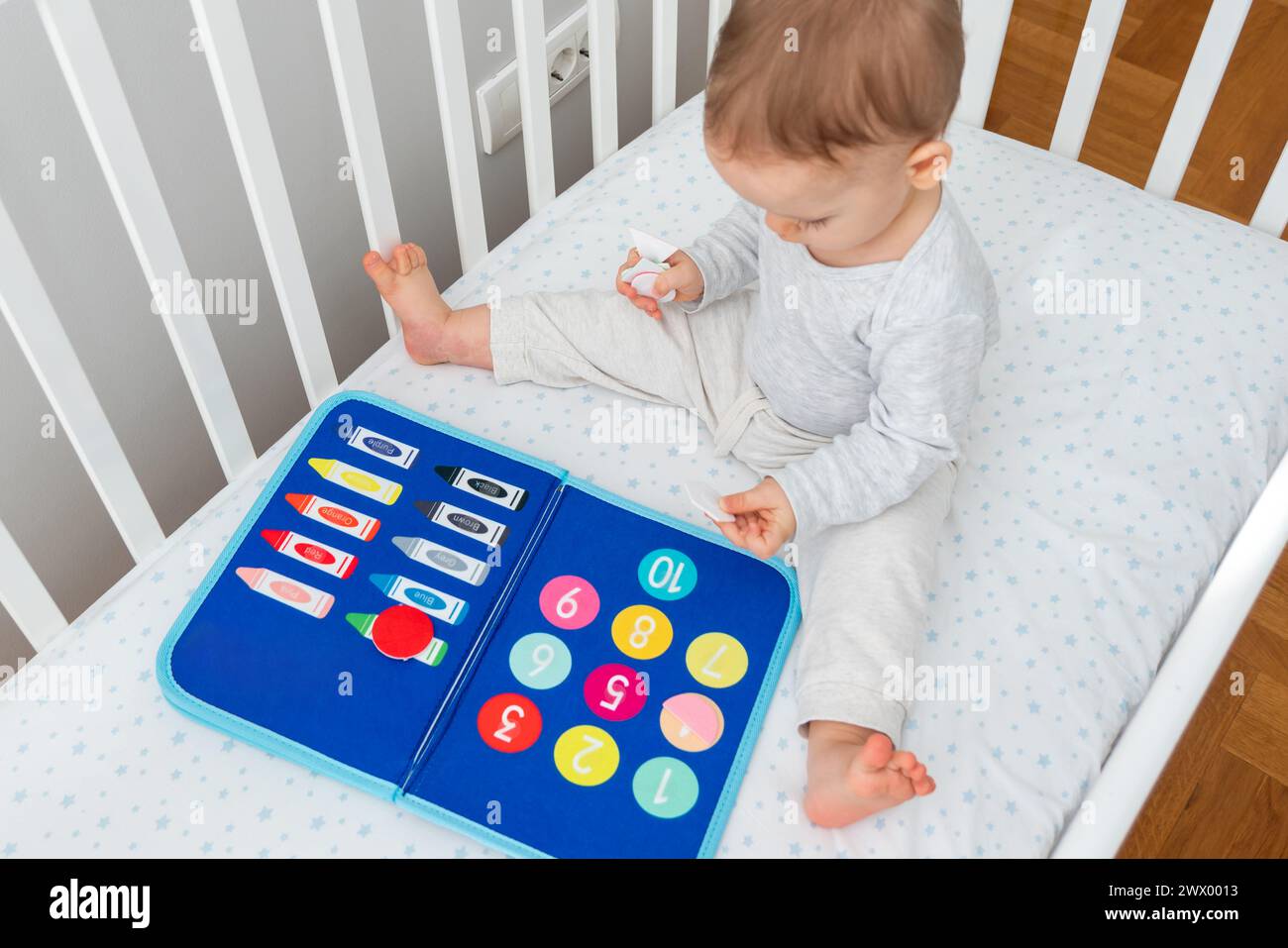 Baby in crib with books hi-res stock photography and images - Alamy