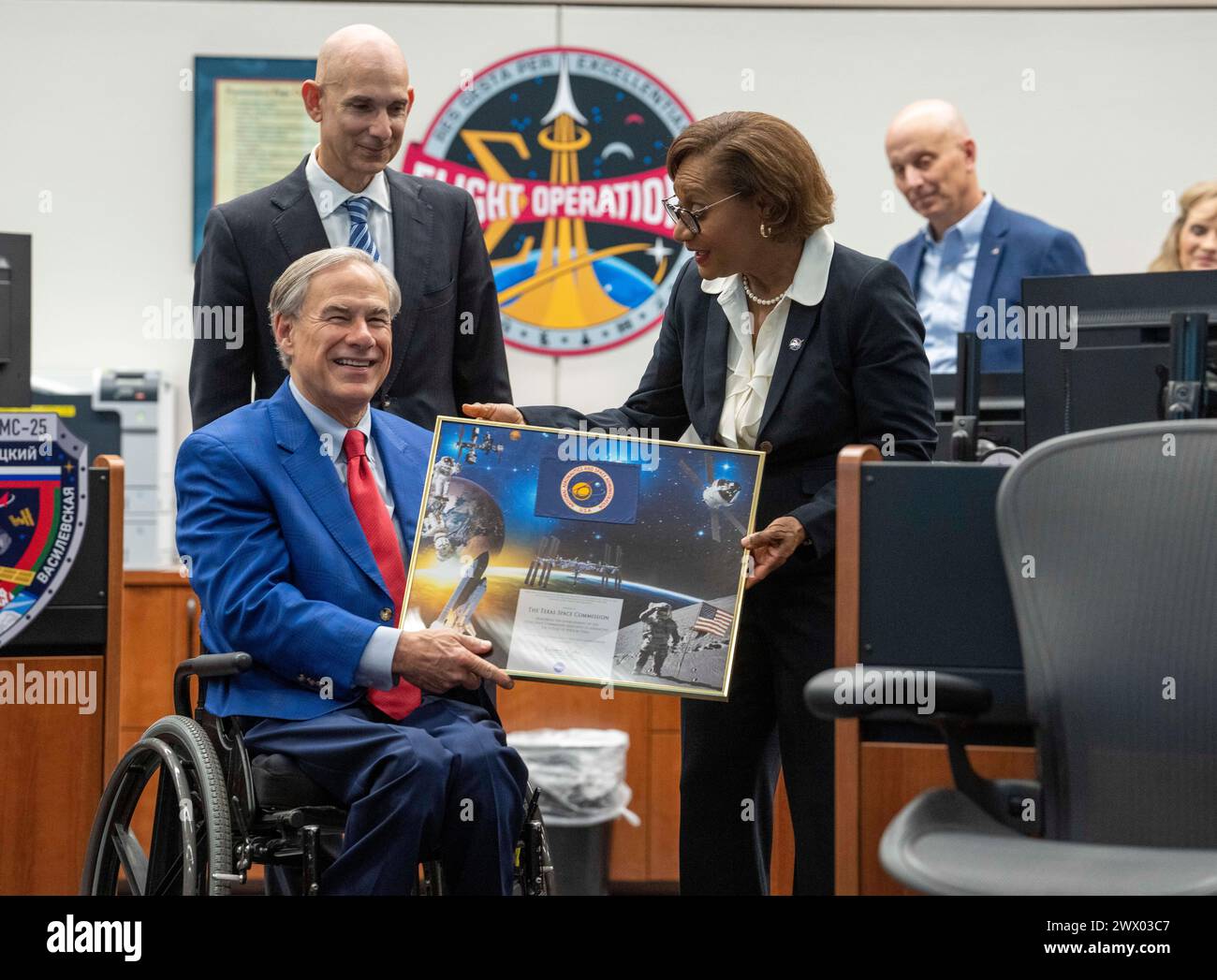 Houston, Tx, USA. 26th Mar, 2024. Texas Governor GREG ABBOTT, l, holds ...