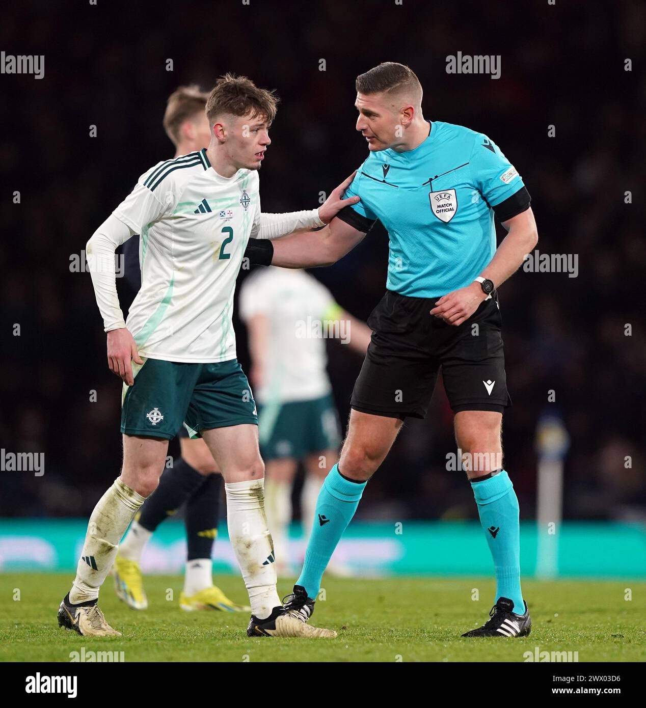 Referee Robert Jones with Northern Ireland's Conor Bradley during a ...
