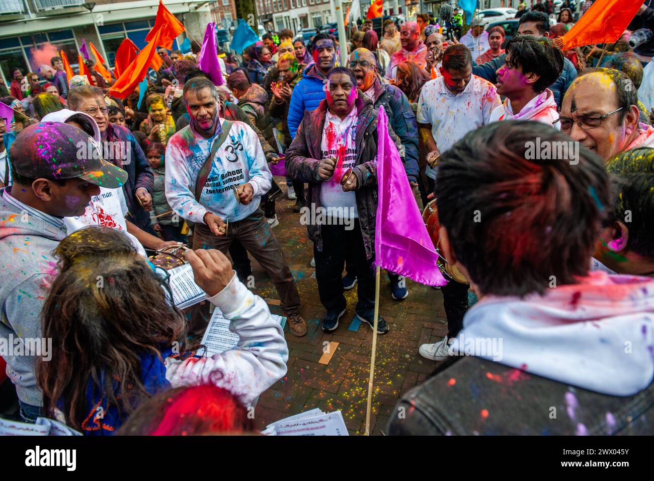 A music band is seen surrounded by people dancing and singing. Millions ...