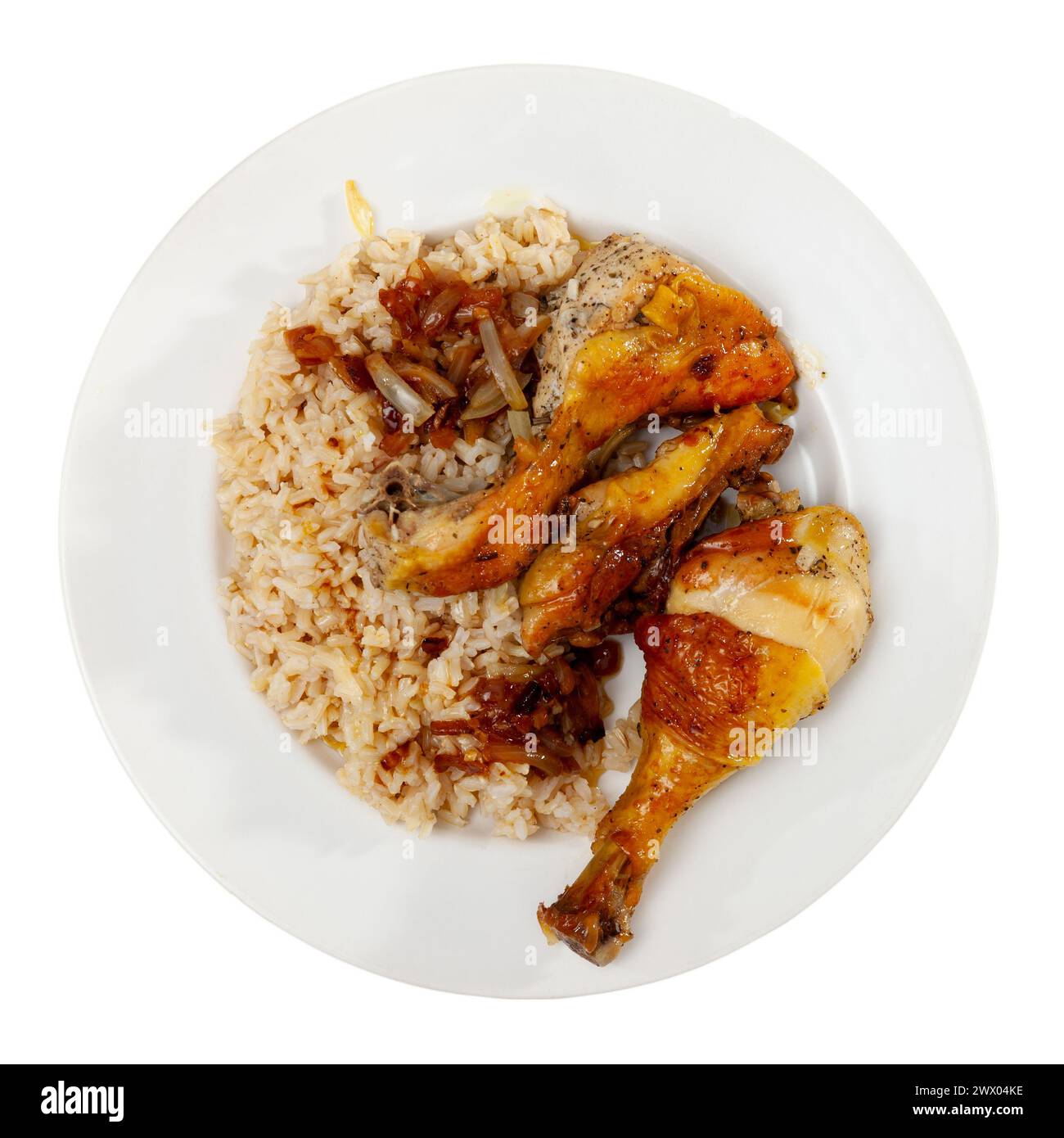 Boiled rice with vegetable gravy and piece of fried chicken is served ...